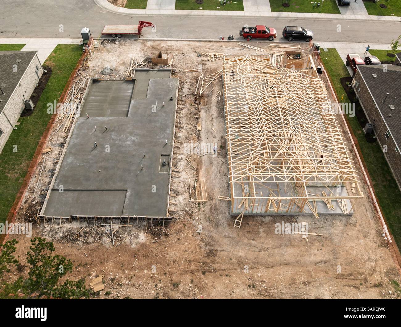 Aerial view of newly poured concrete slab next to home that is being ...