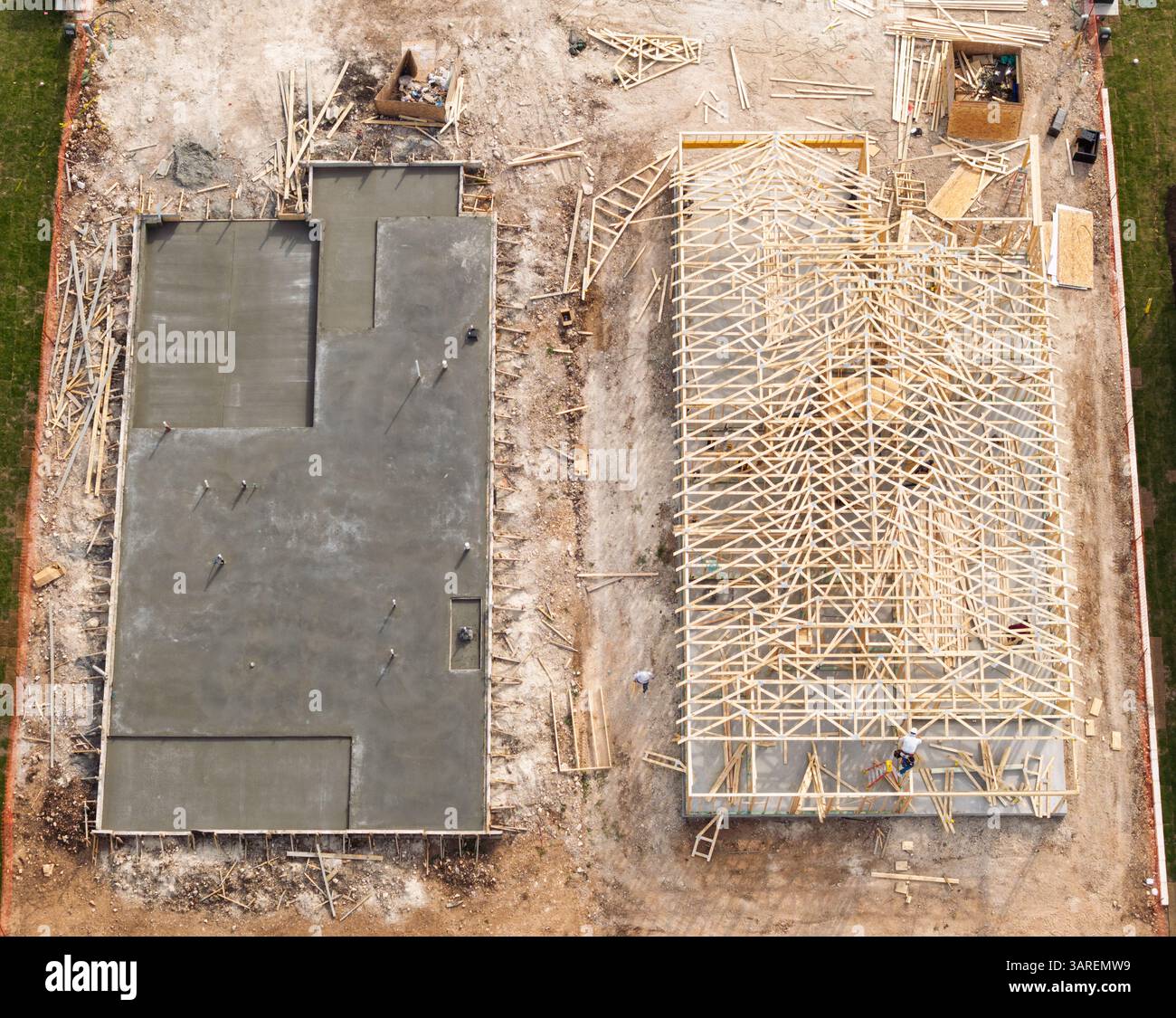 Aerial view of newly poured concrete slab next to home that is being ...