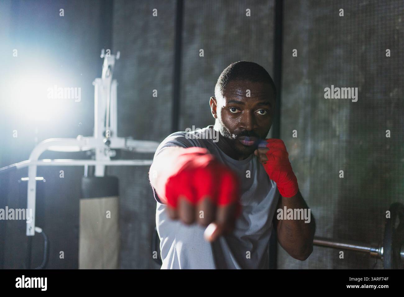 Workout in gym. African man fighter ready for fight punching with ...