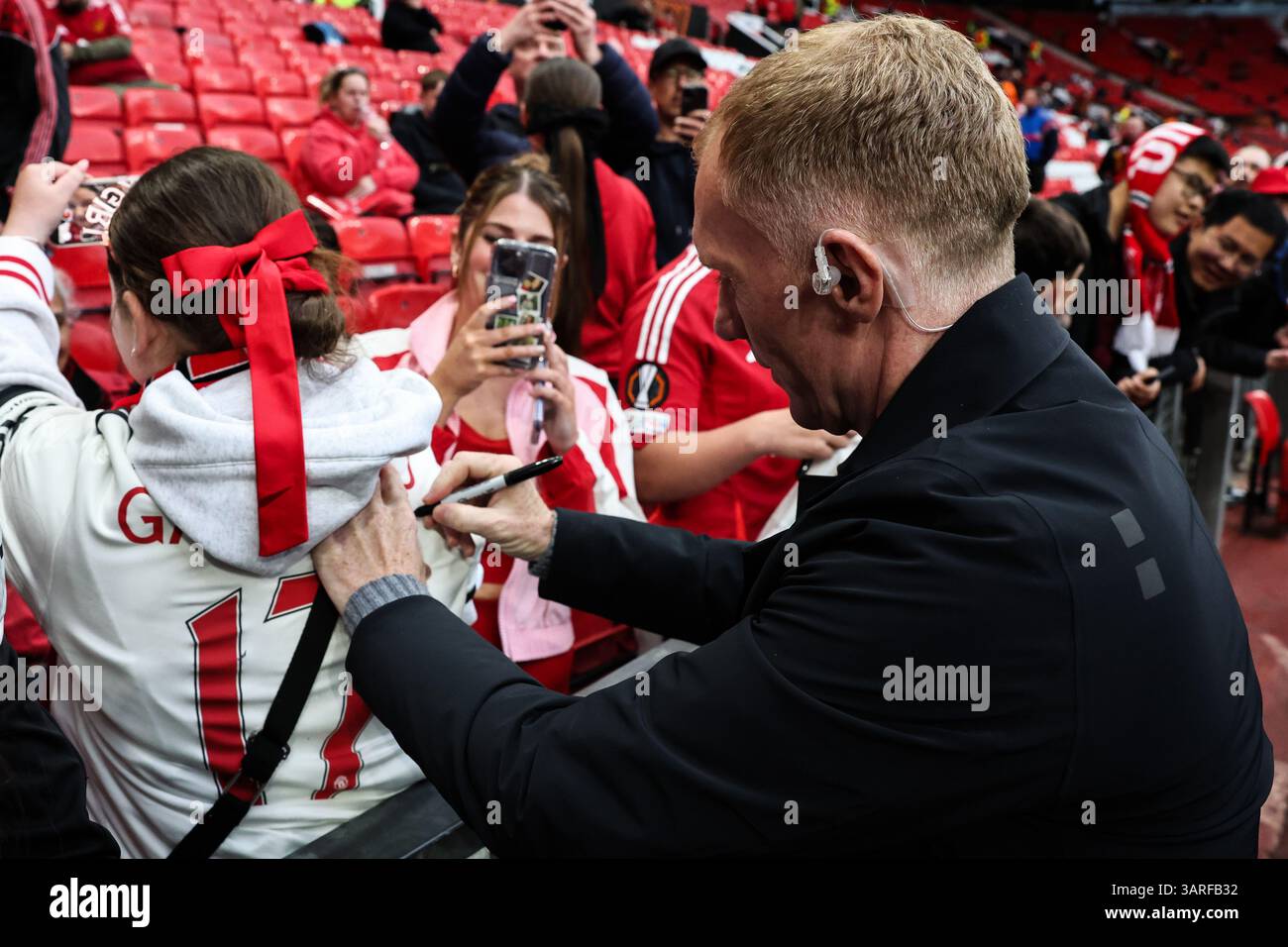 Paul Scholes former Manchester United player signs a fans shirt ahead ...
