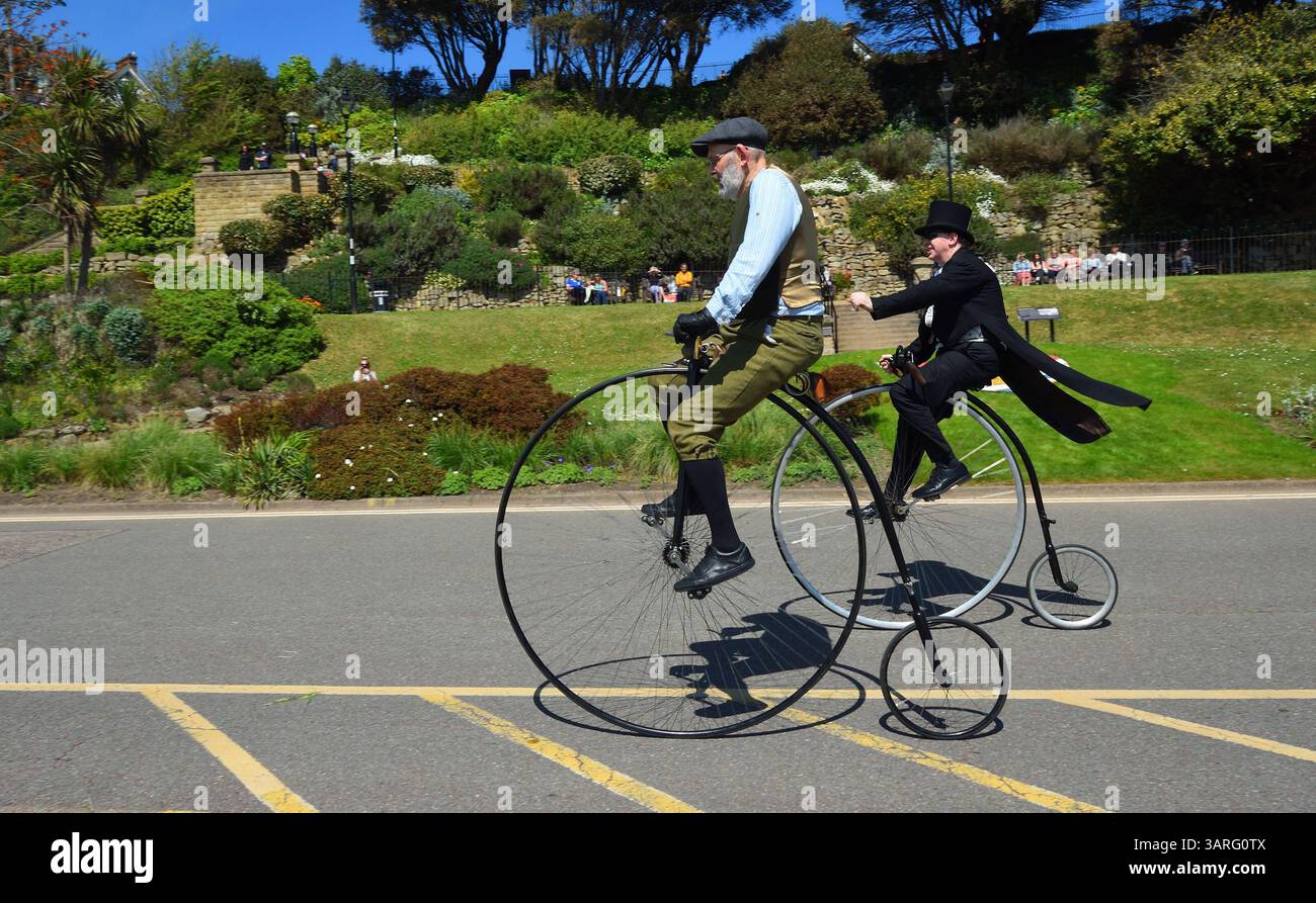 Two men riding Penny Farthing biclyes in vintage clothes Stock Photo ...