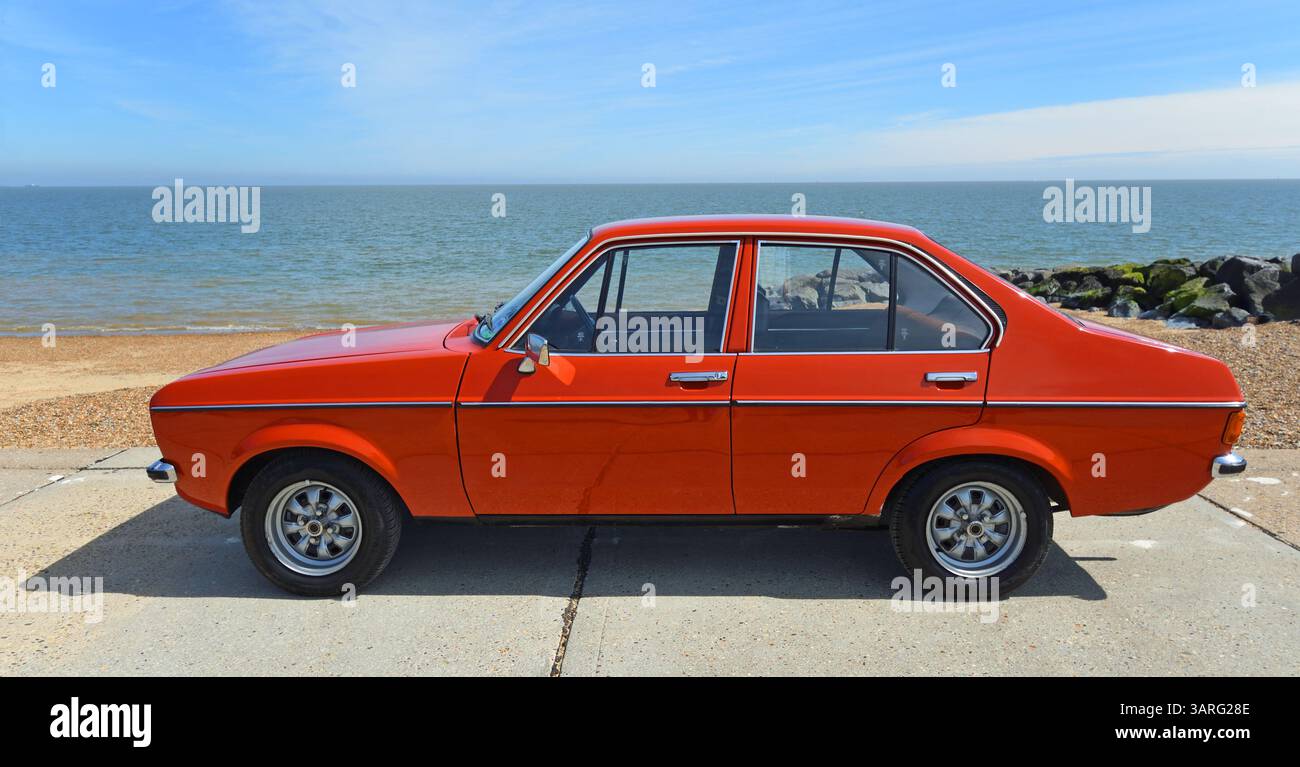 Classic Ford Escort Mk.II parked on seafront promenade beah and sea in ...