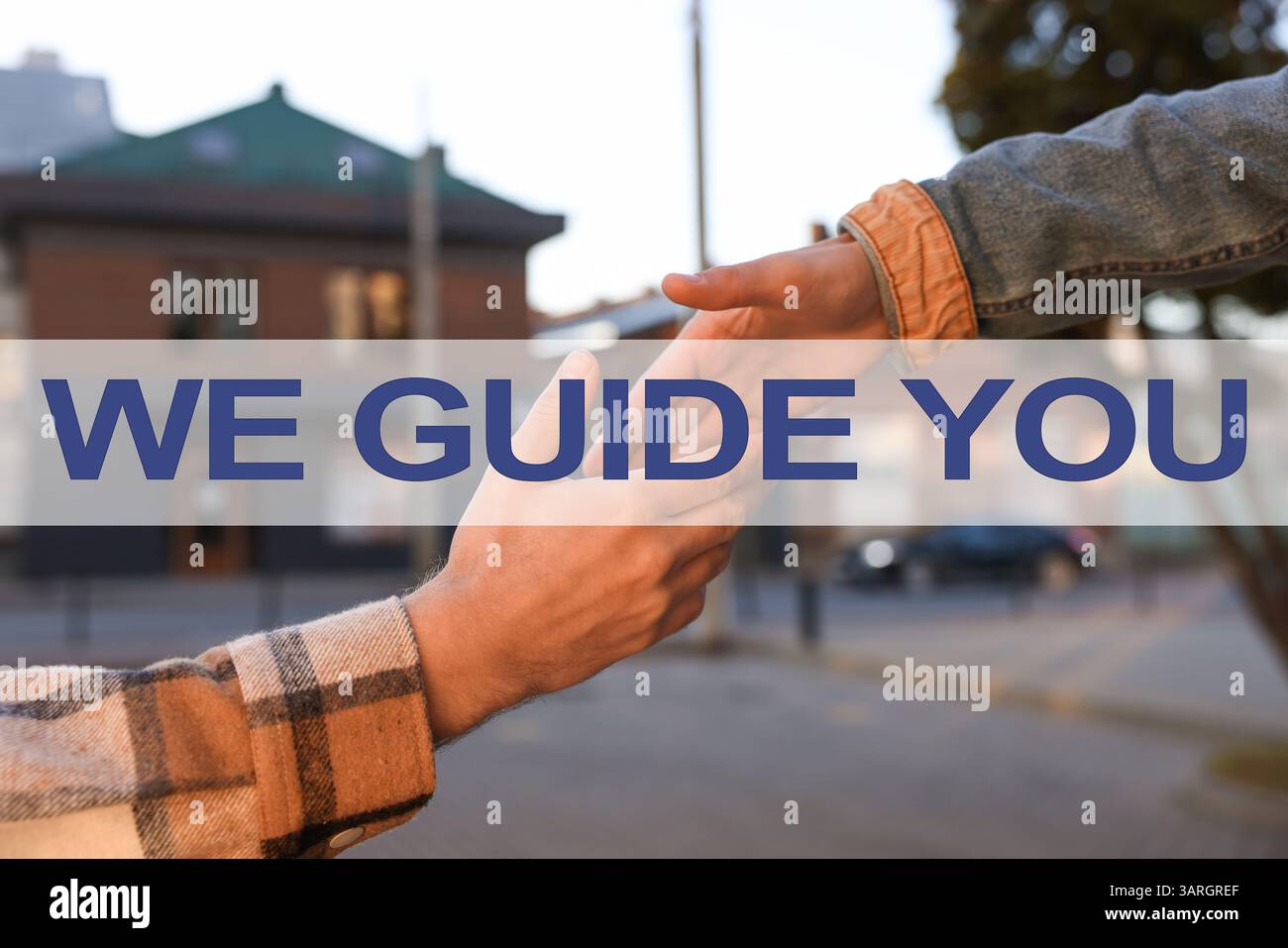 We guide you. People greeting with shaking hands outdoors, closeup ...
