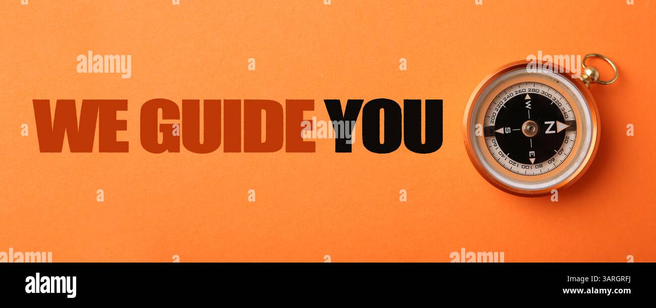 We Guide You text and compass on orange background, top view. Banner ...
