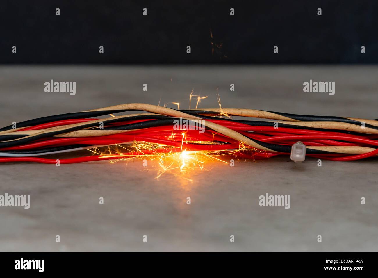 there is a fire burning in the electric wires, sparks fly on a dark ...