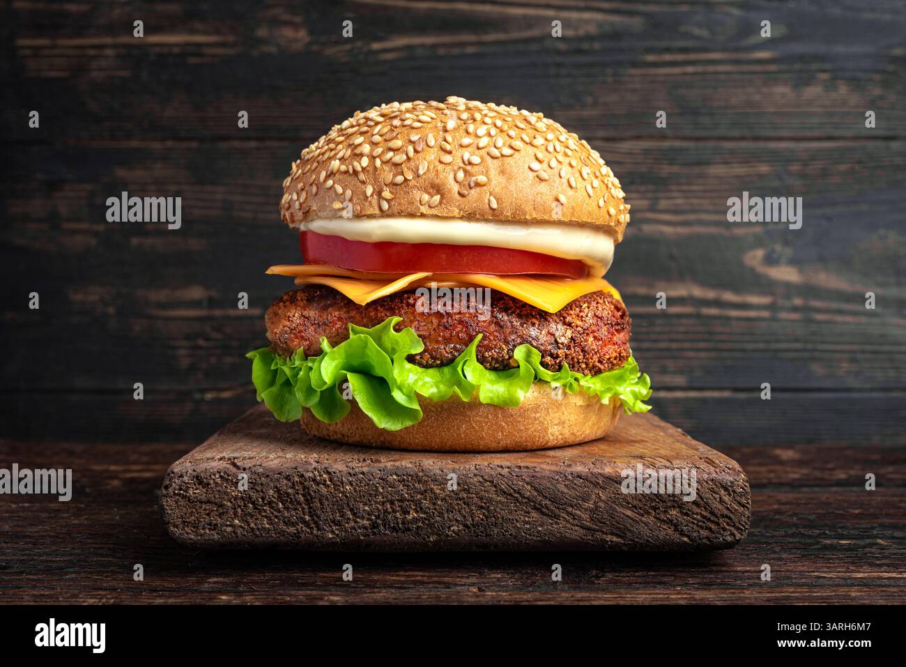 Homemade chicken burger, cheeseburger with lettuce, cheese, sauce and ...