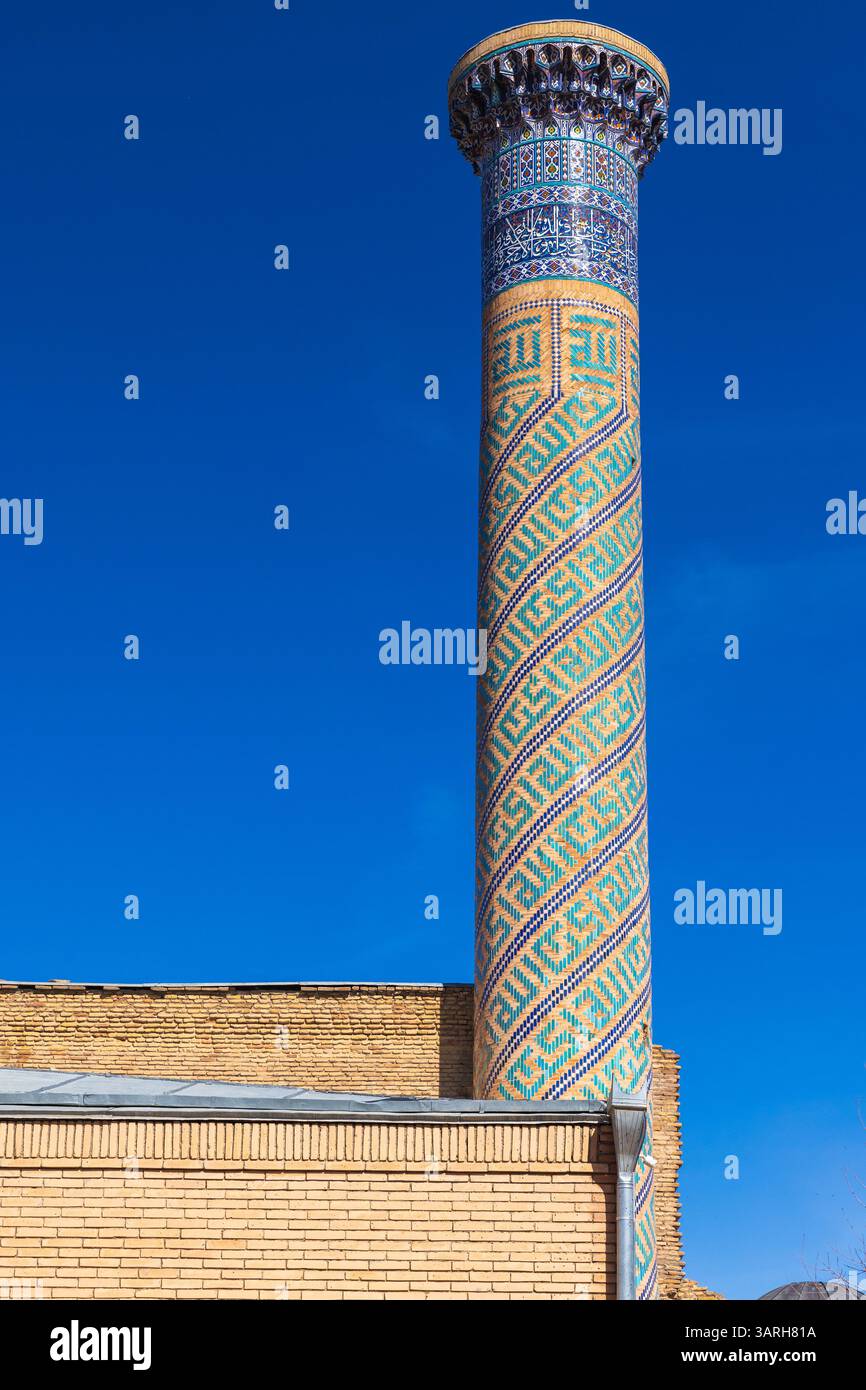 Minaret of Gur-e-Amir is under blue sky, it is a mausoleum complex of ...