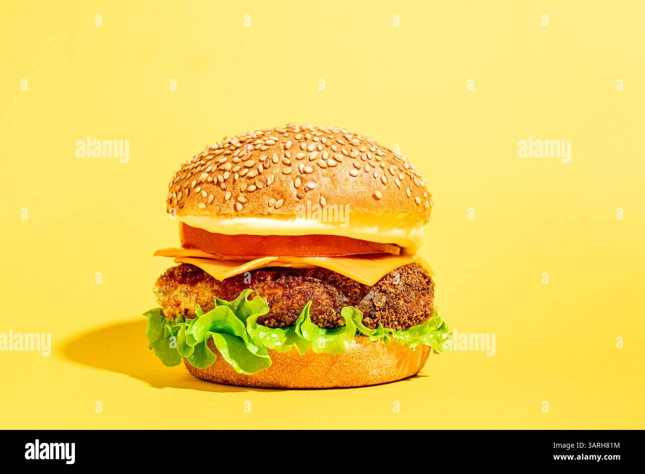 Chicken burger, cheeseburger on bright yellow background, creative ...