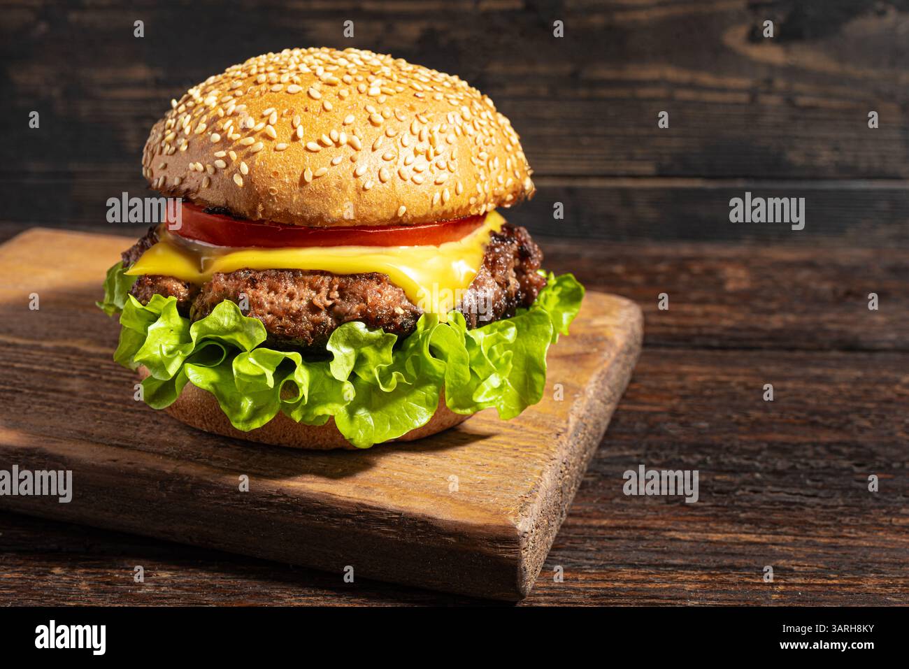 Homemade burger, cheeseburger on dark wooden background, copy space ...