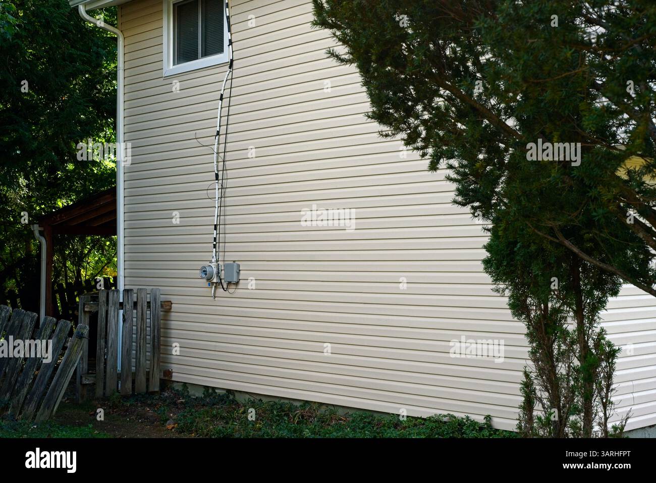 Side wall of a two-story house with new vinyl siding and gutter system ...