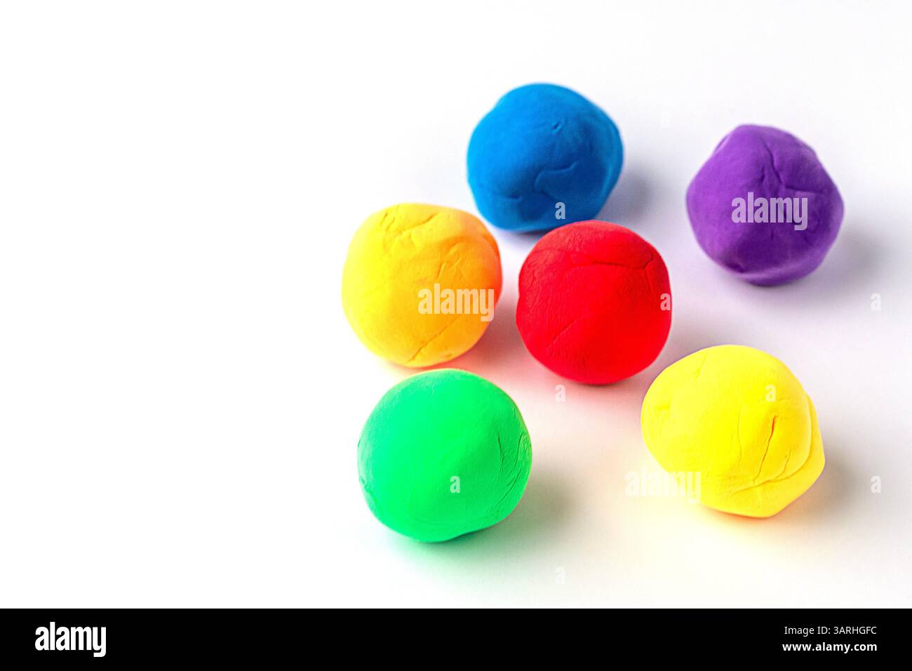 Brightly colored modeling clay balls beautifully displayed on a simple ...