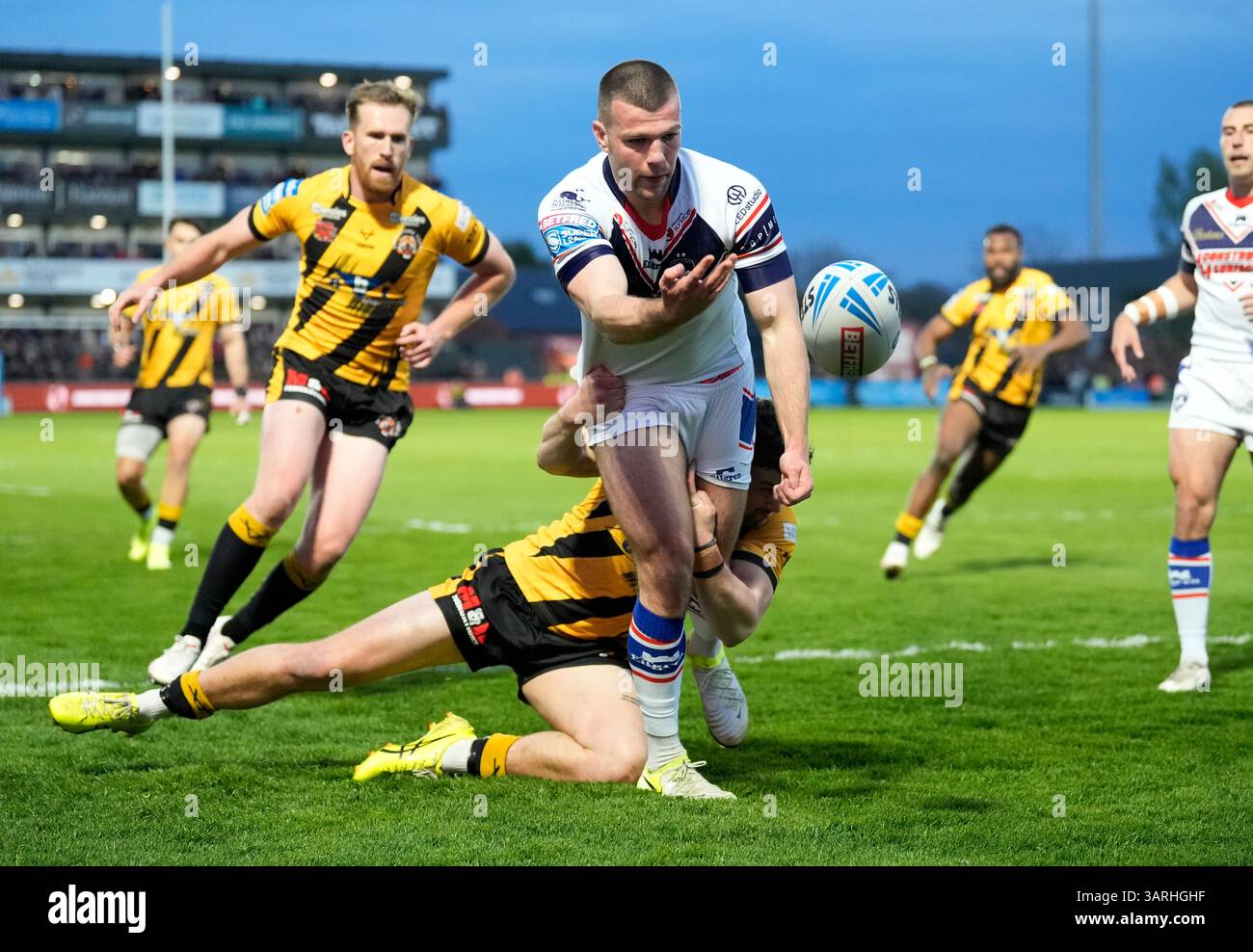 Wakefield's Max Jowitt is tackled by Castleford's Josh Simm during the ...