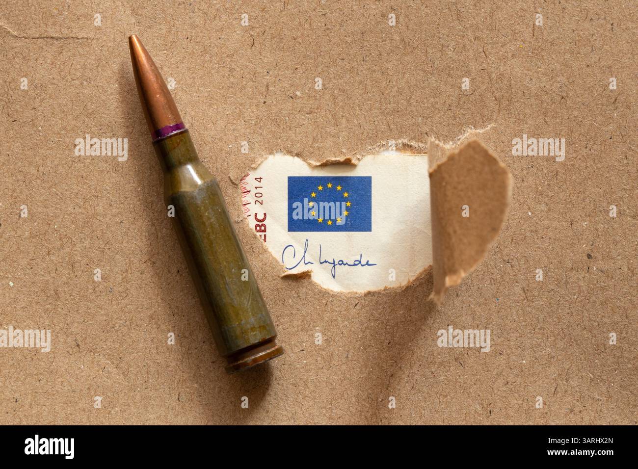 A hole in the paper through which the EU flag is visible on a ten euro ...