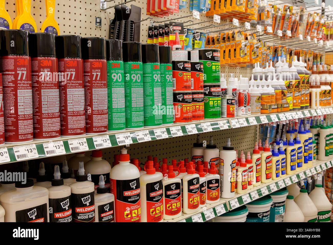 Various glues for sale inside Hardware store Stock Photo - Alamy