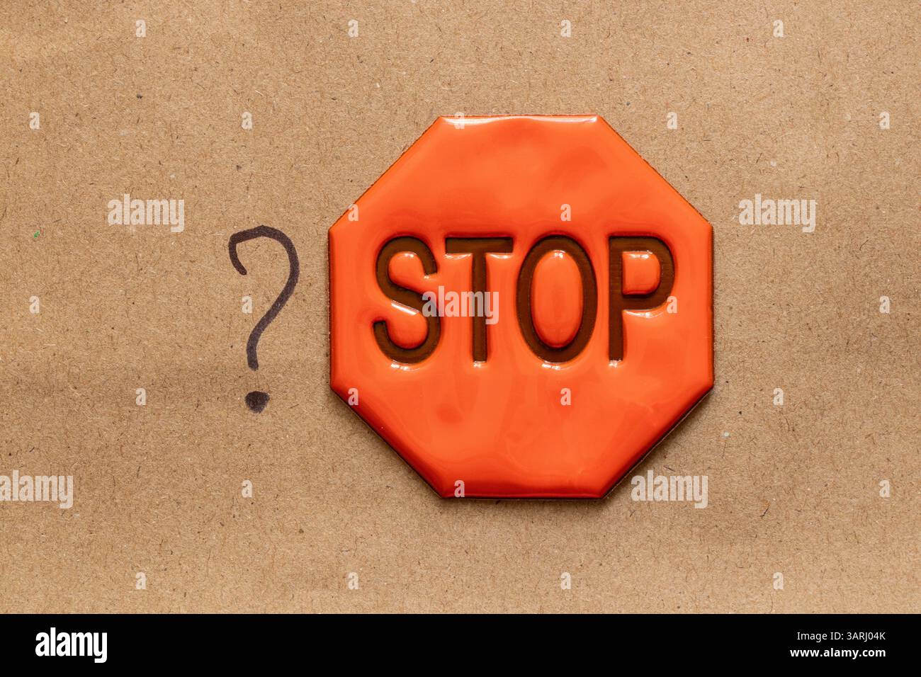 Hand drawn question mark and reflexive sign with stop text on brown ...
