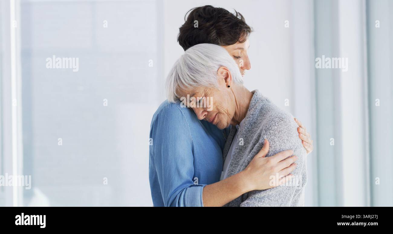 Sad, comfort and woman hugging senior mother in retirement home for ...