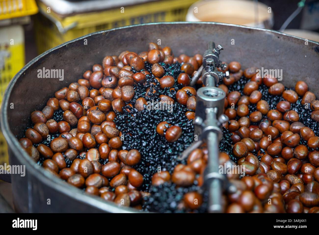 Roasting Chestnuts churning with coal Stock Photo - Alamy