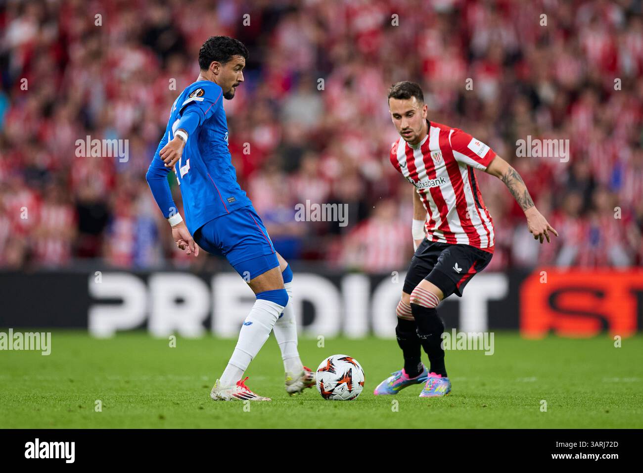 Jefte Vital da Silva Dias of Rangers FC competes for the ball with Alex ...