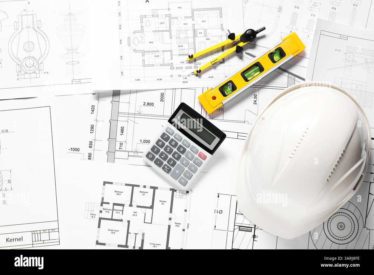 Hard hat, divider, calculator and building level on different ...
