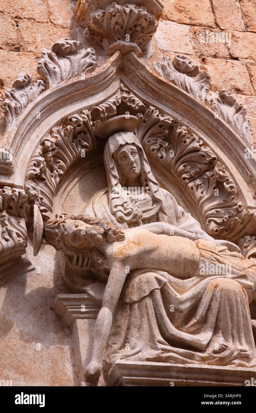 Baroque period sculpture of a 'Pieta' on a church exterior wall in ...