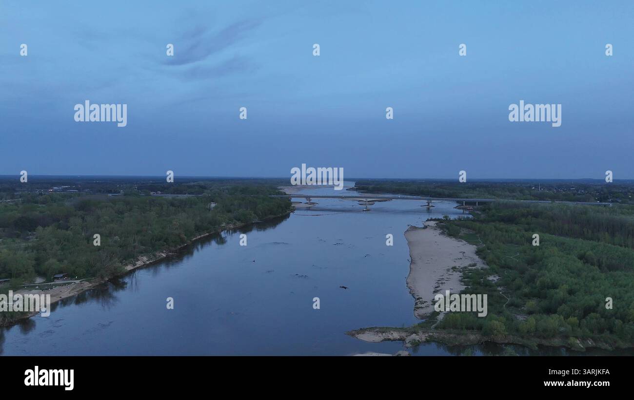 River Wisla with a bridge in the middle. The sky is blue and the water ...