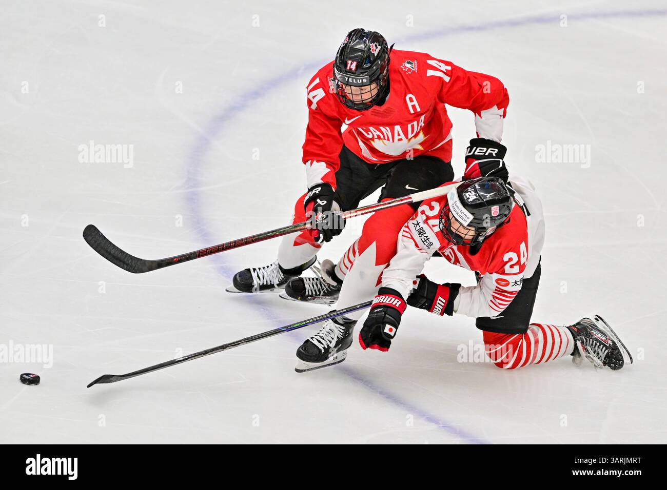 L-R Renata Fast (CAN) and Mei Miura (JPN) in action during the IIHF ...