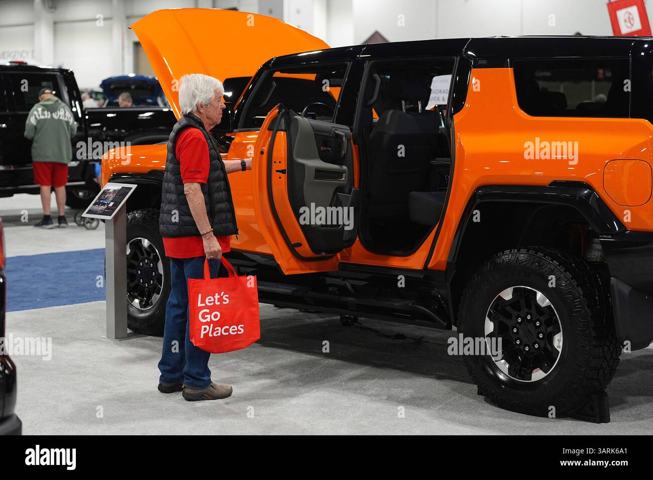 A shopper closes the door on a 2025 Hummer electric utility vehicle at ...