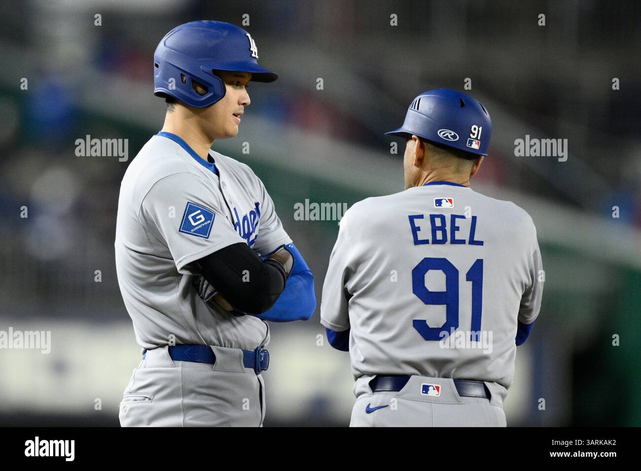 Los Angeles Dodgers' Shohei Ohtani talks with third base coach/outfield ...