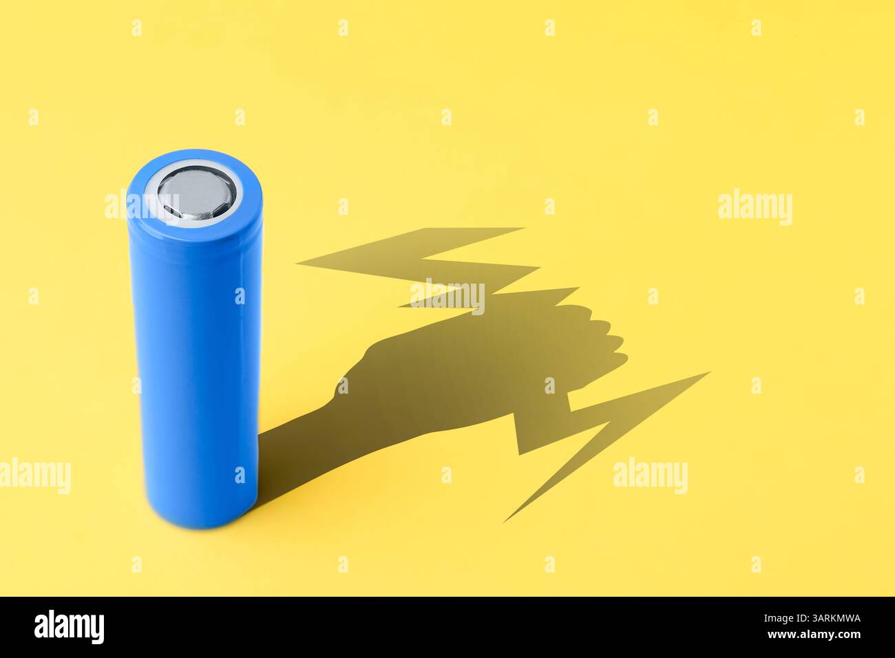 Alkaline battery with shadow in shape of hand holding lightning on ...
