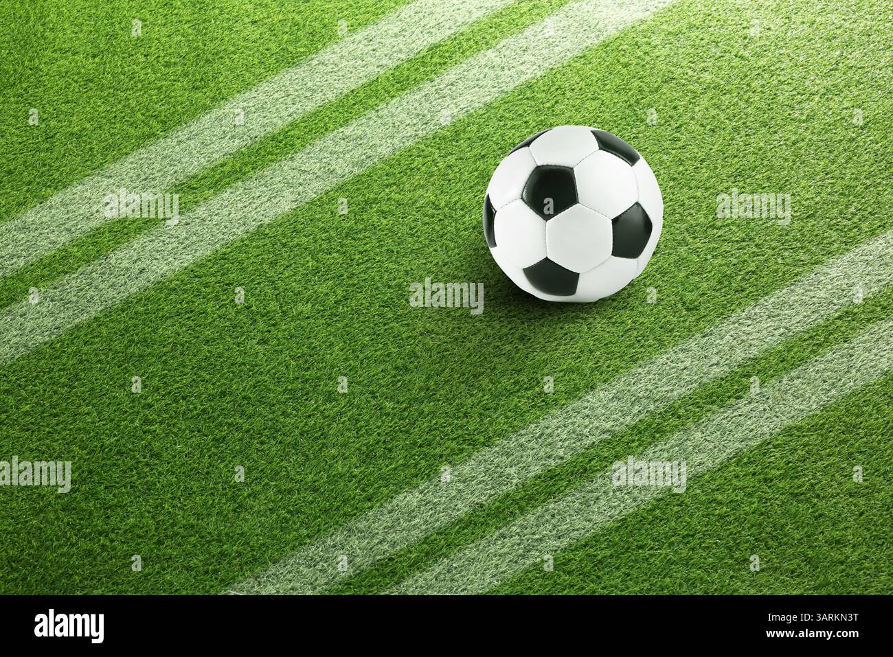 Soccer ball on football field with markings Stock Photo - Alamy