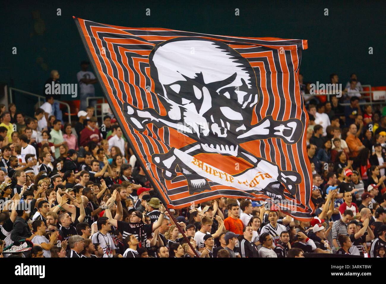 A skull and crossbones flag is displayed by DC United supporters during ...