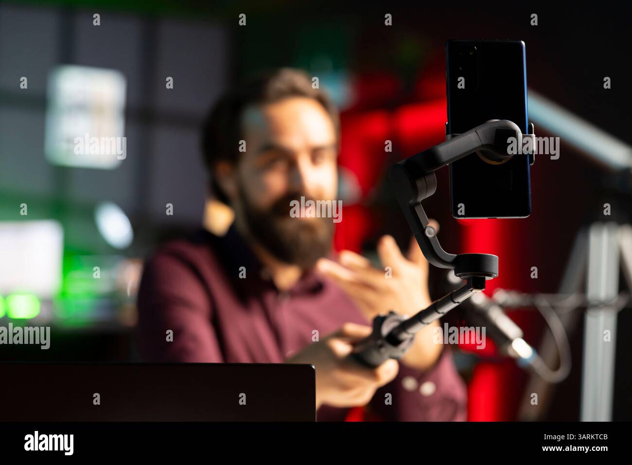 Focus on smartphone used by content creator in blurry background ...