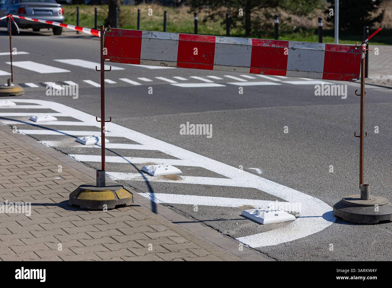 Freshly painted road markings with temporary barrier on residential ...