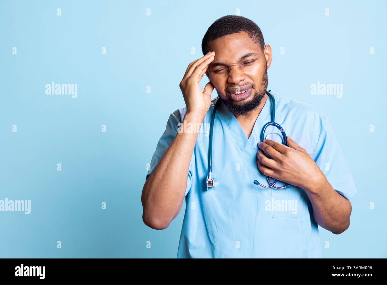 Fatigued tired nurse suffering from painful migraine after tiresome day ...