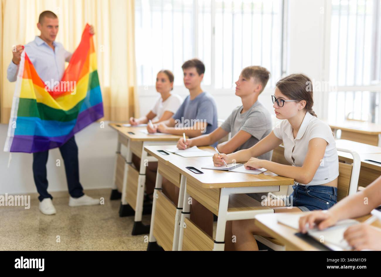 School teacher with flag explains to students what is LGBT Stock Photo ...
