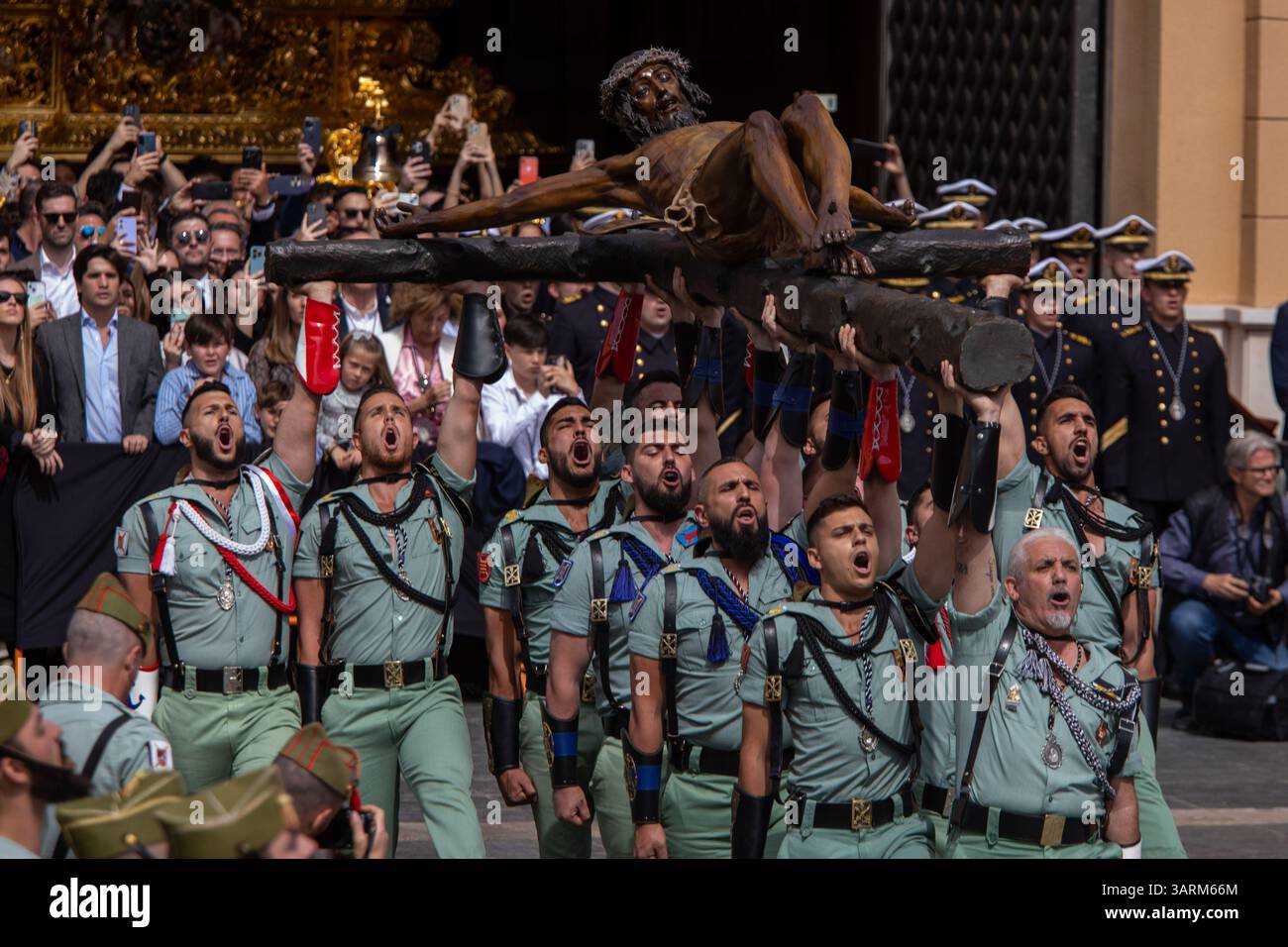 April 17, 2025, Malaga, Spain: A group of legionnaires carry the Christ ...