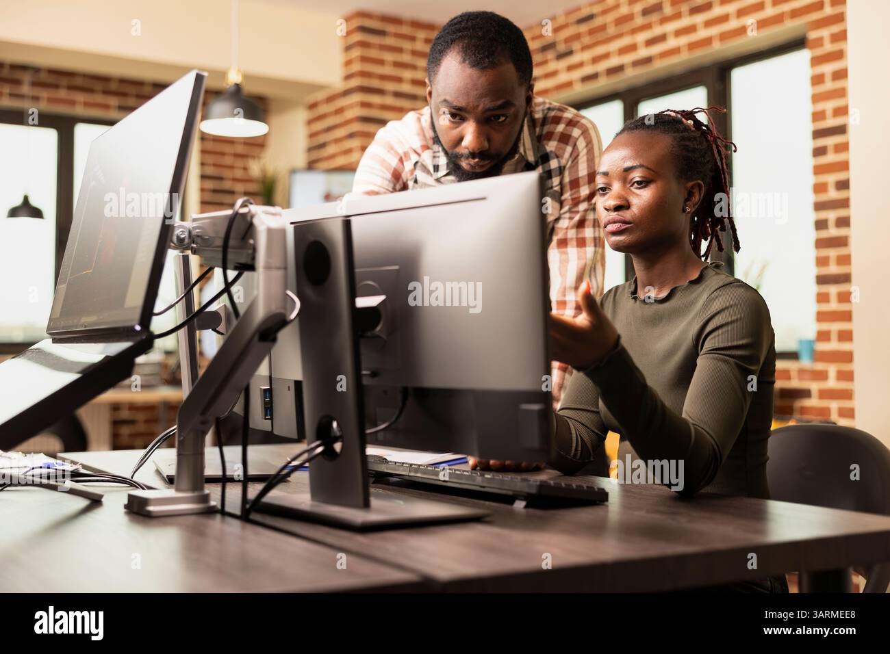 African American coworkers collaborate on product designs, exchanging ...