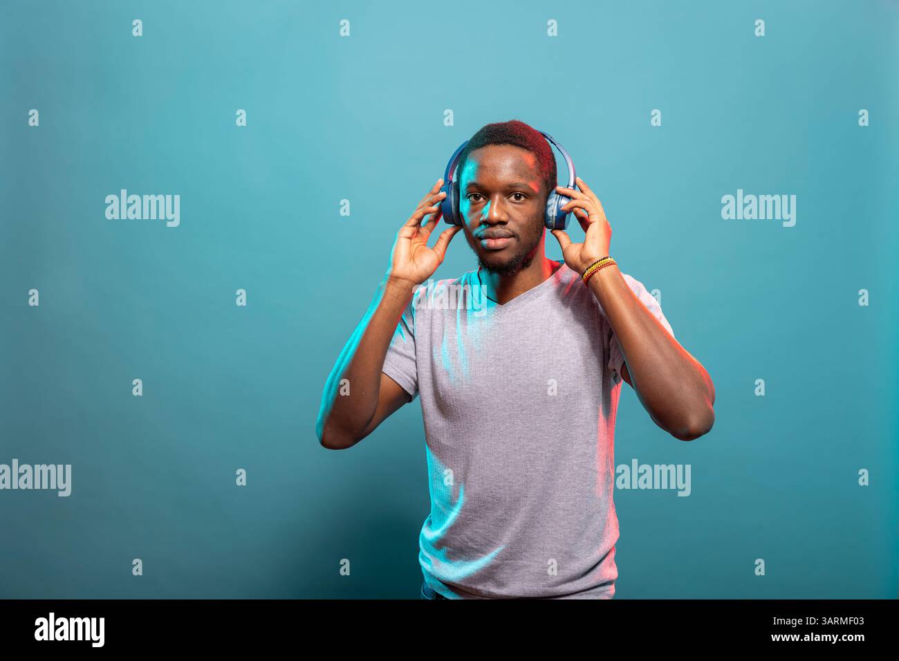Portrait of african american man wearing wireless headphones and ...