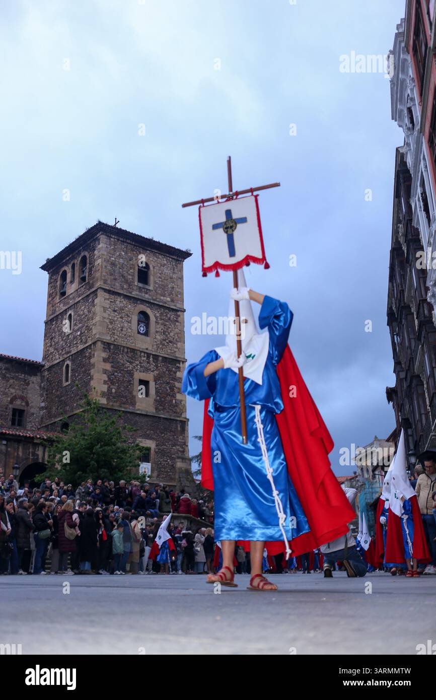 Avilés, Spain, April 17, 2025: One of the Nazarenes carrying a cross ...