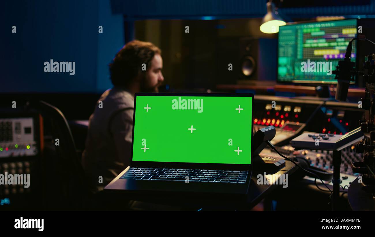 Sound designer uses audio mixer and greenscreen layout in professional ...