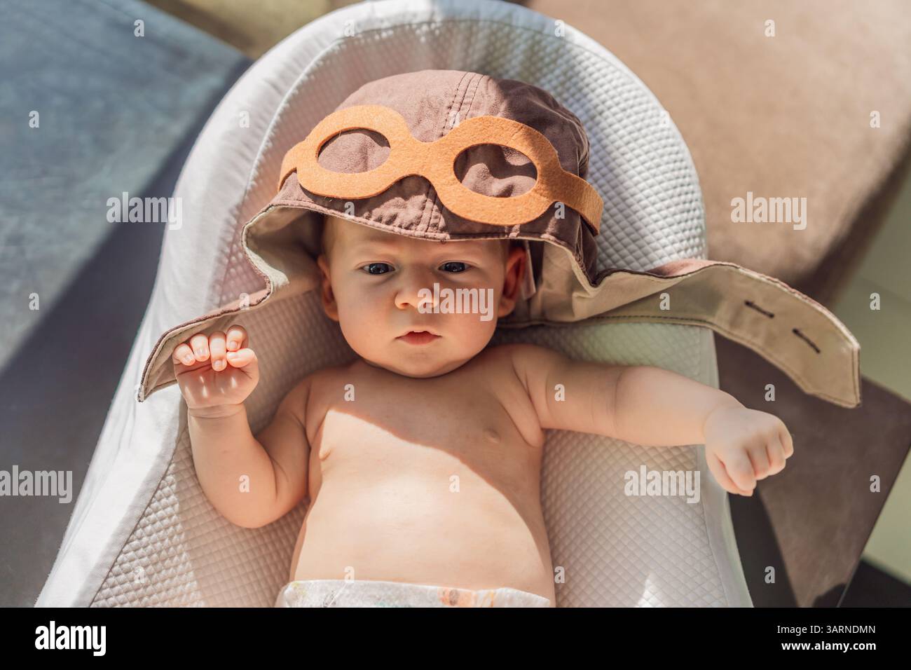 Baby wearing a pilot hat, symbolizing early dreams of aviation. Concept ...