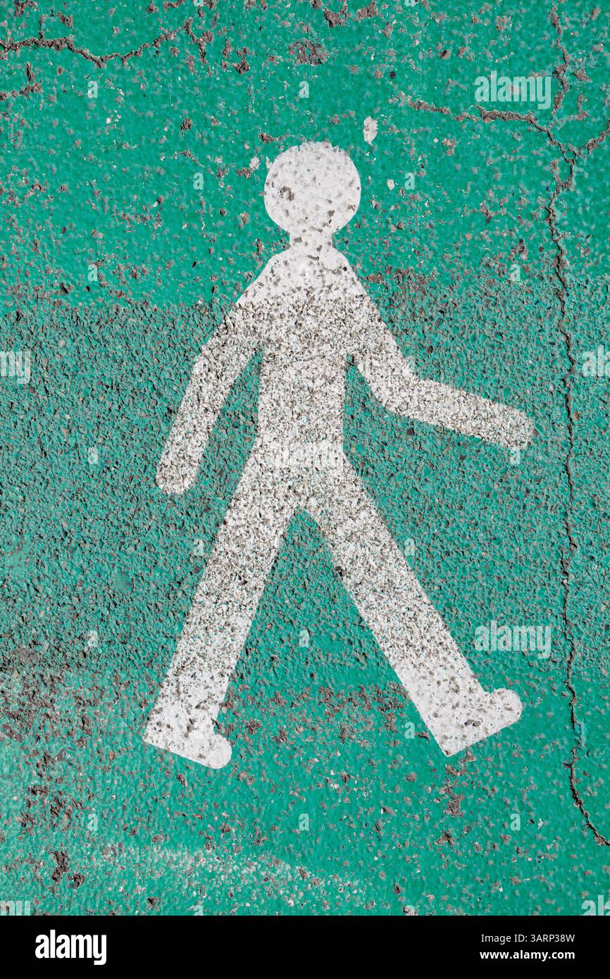 rotten pedestrian walking sign in white on green background in France ...