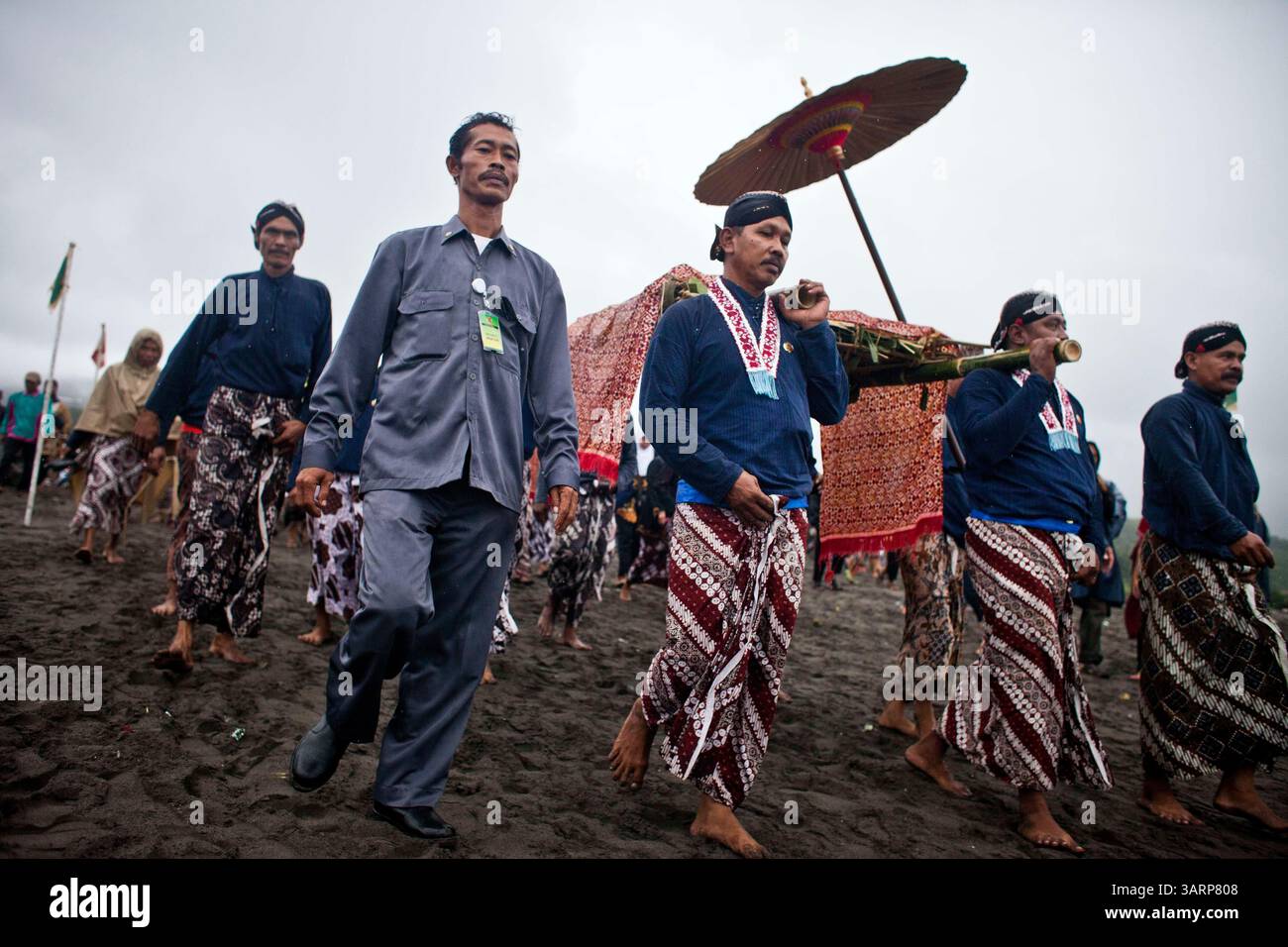 Royal Servants wearing traditional Javanese costume carry offerings to ...