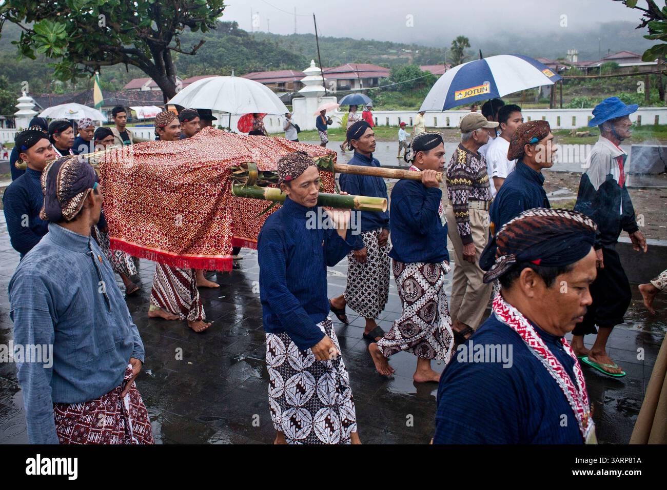 Royal Servants wearing traditional Javanese costume carry offerings to ...
