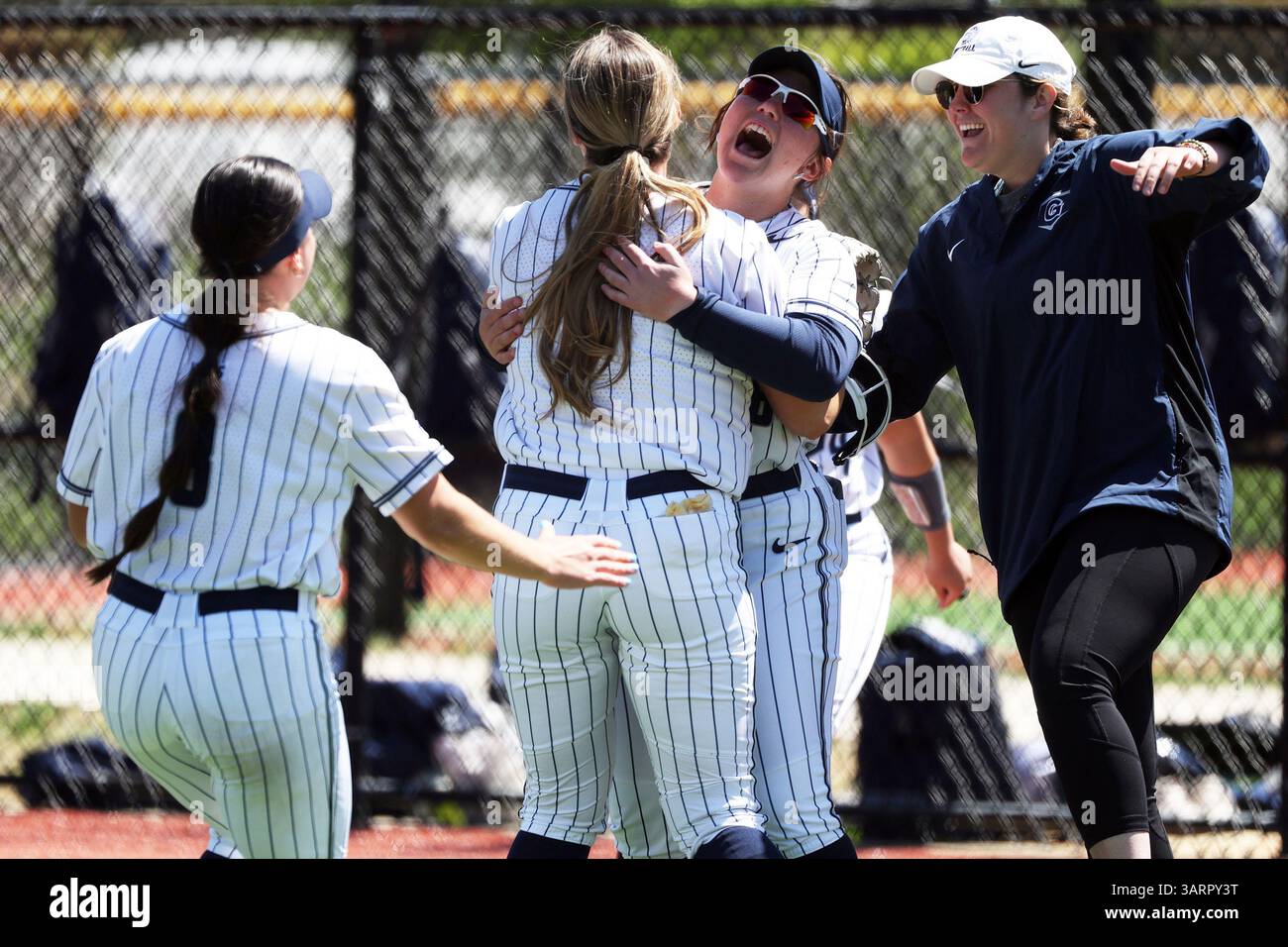 Georgetown players celebrate after an NCAA softball game against ...