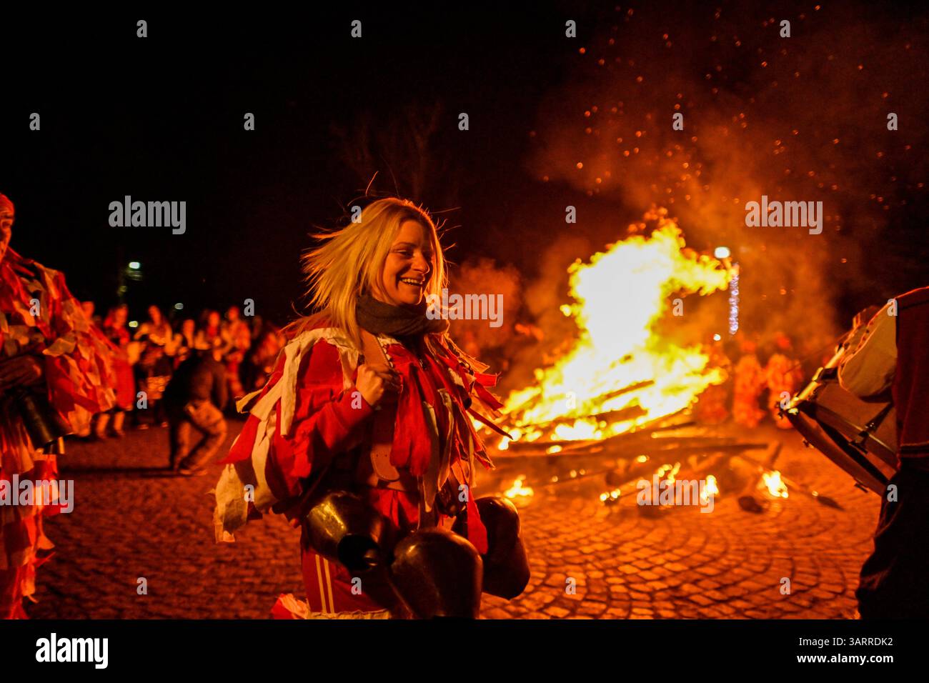 As night falls over Breznik, the Kukeri gather around a roaring ...