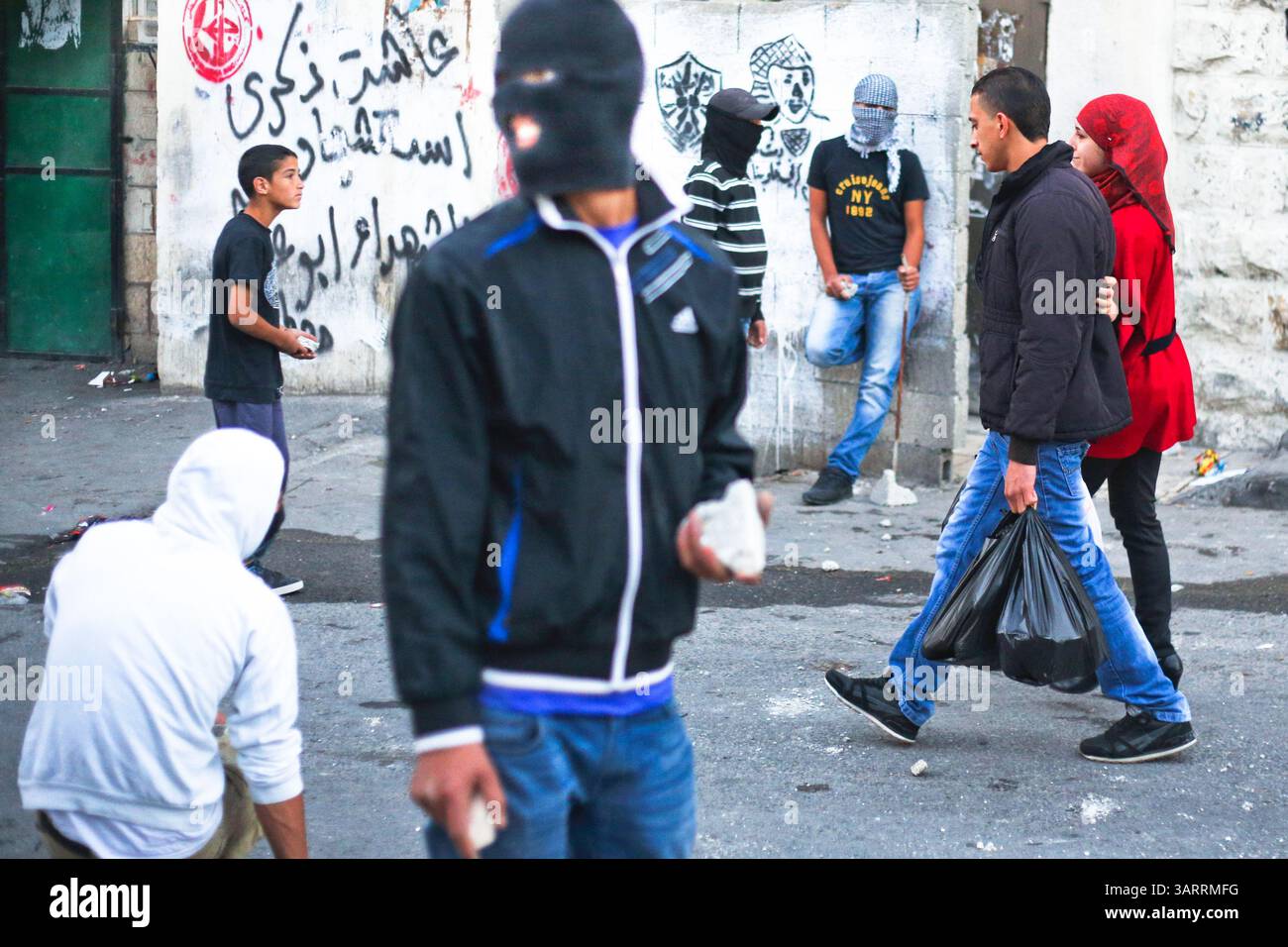 November 15, 2012 - Jerusalem, Israel - A Palestinian couple pass by ...