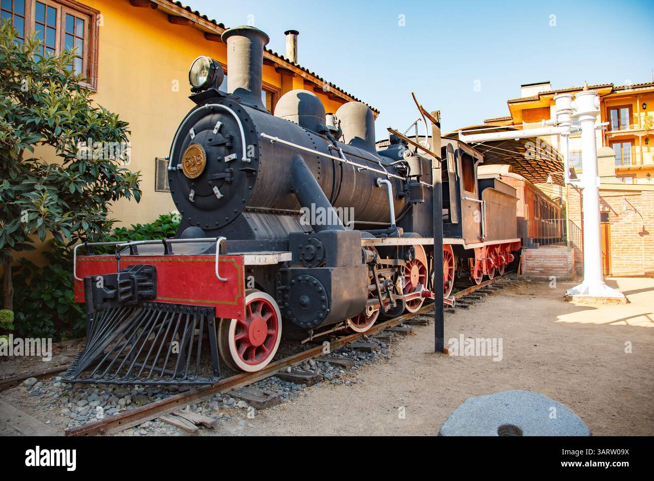 A Vintage steam locomotive in front of colonial style Santa Cruz hotel ...