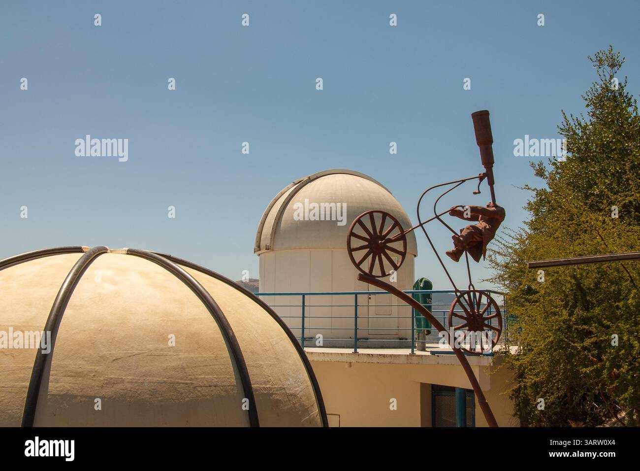 The Sculpture of a man with a telescope on a bicycle and the astronomy ...