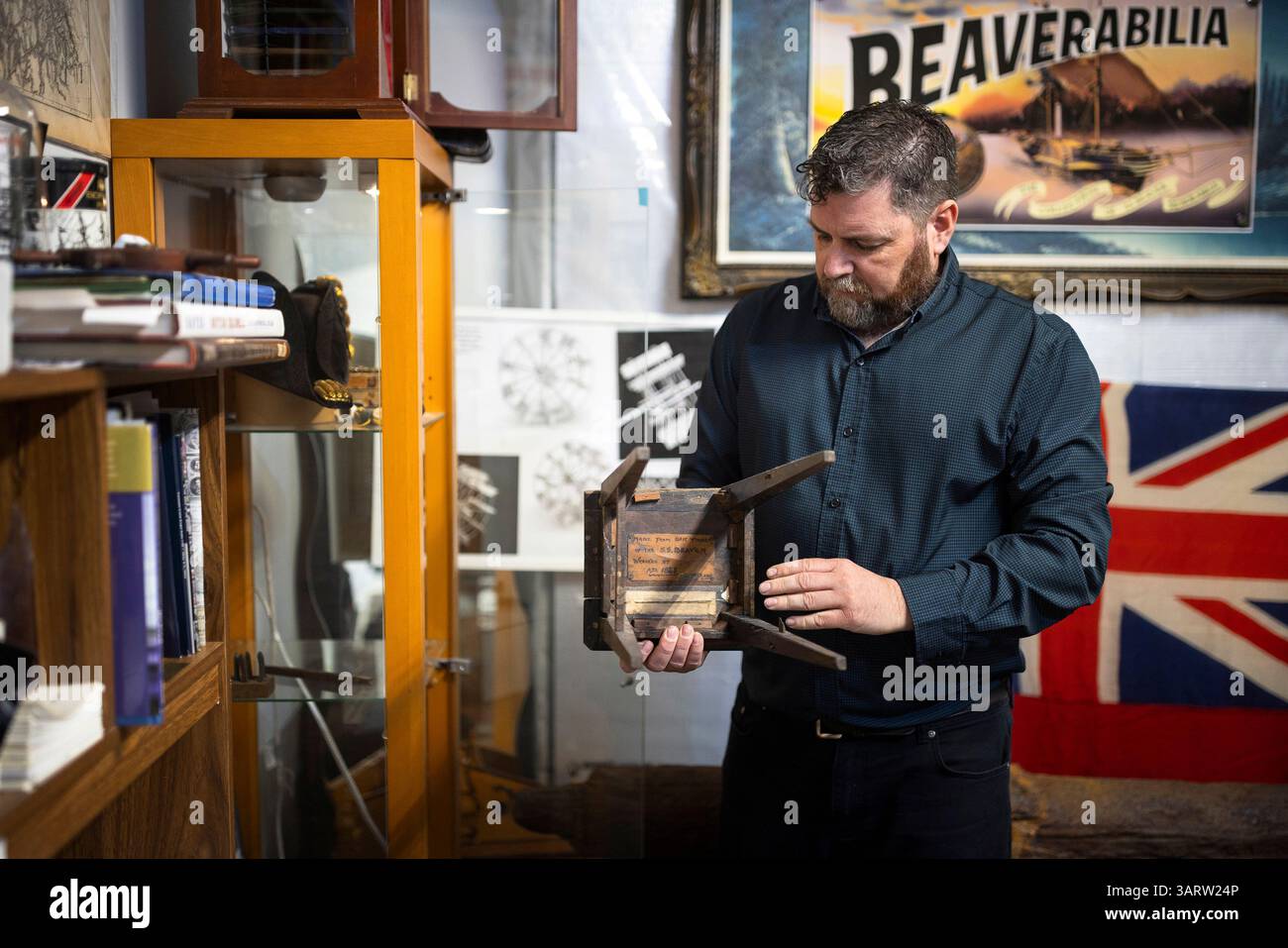 Mark Garner handles a chair from 1888 made out of wood from the S.S ...